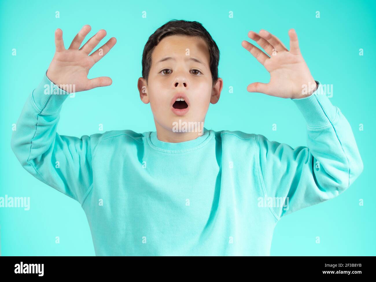 Portrait of beautiful emotional little boy on green background Stock ...