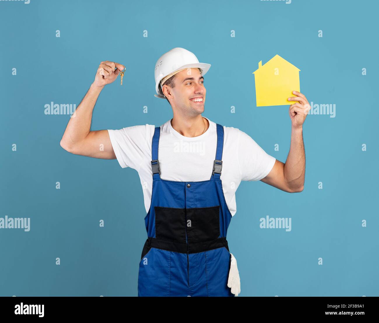 Happy Handyman In Coverall And Hardhat Holding Keys And Paper House ...