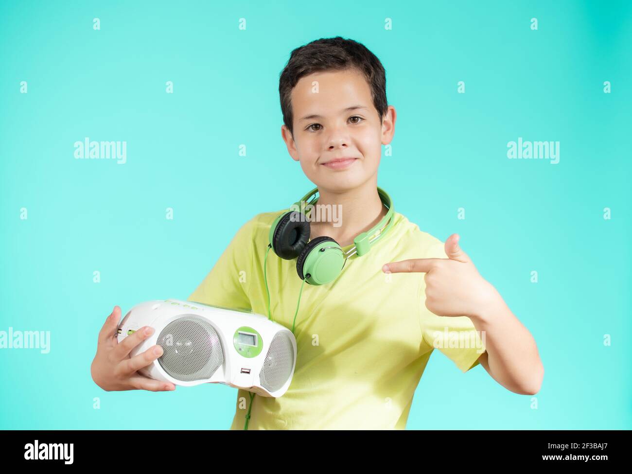 Young boy with headphones and radio over green background Stock Photo ...