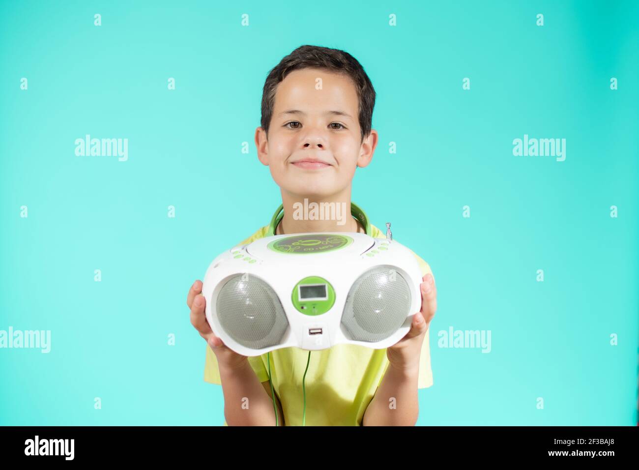 Young boy with headphones and radio over green background Stock Photo ...