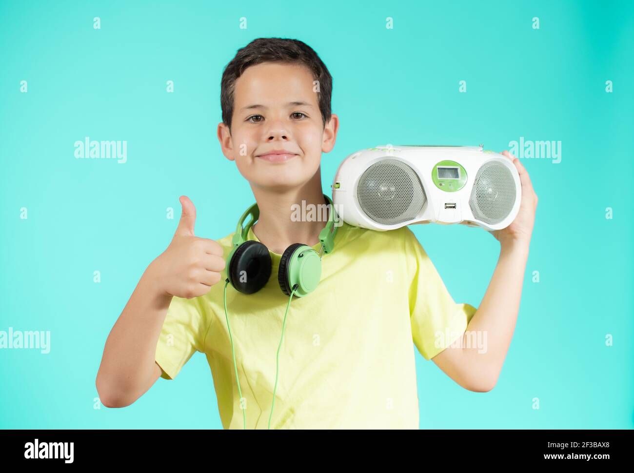 Young boy with headphones and radio over green background Stock Photo ...