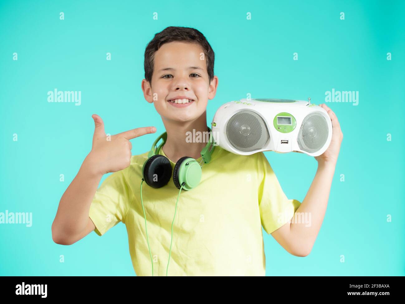 Young boy with headphones and radio over green background Stock Photo ...
