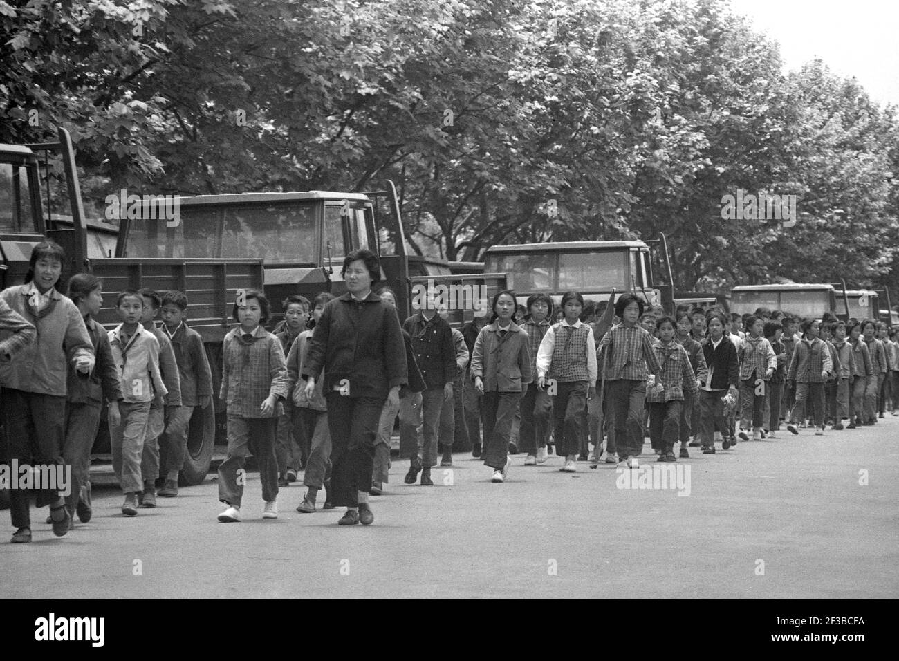 Scene in the country, young Chinese girls marching in a long line, 02. ...