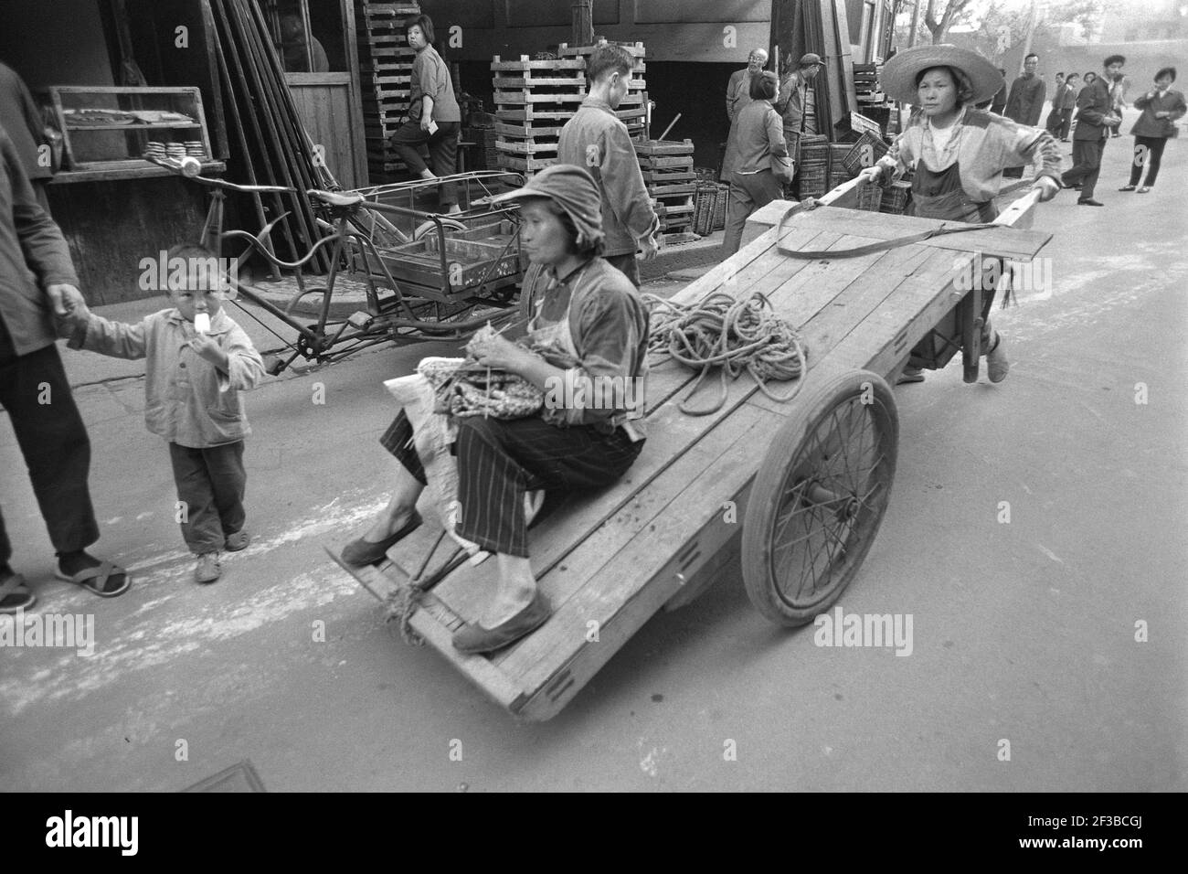 Street scene in Shanghai, Chinese women with a transport cart, 02.06. ...