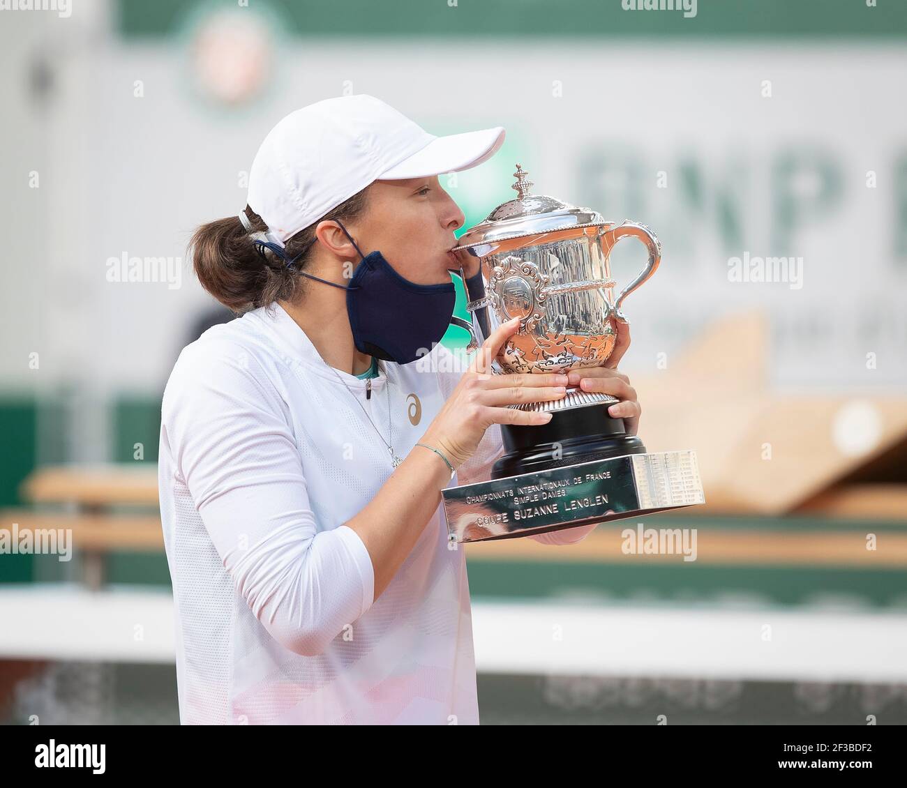 Polish tennis player Iga Swiatek kissing her trophy at the French Open ...