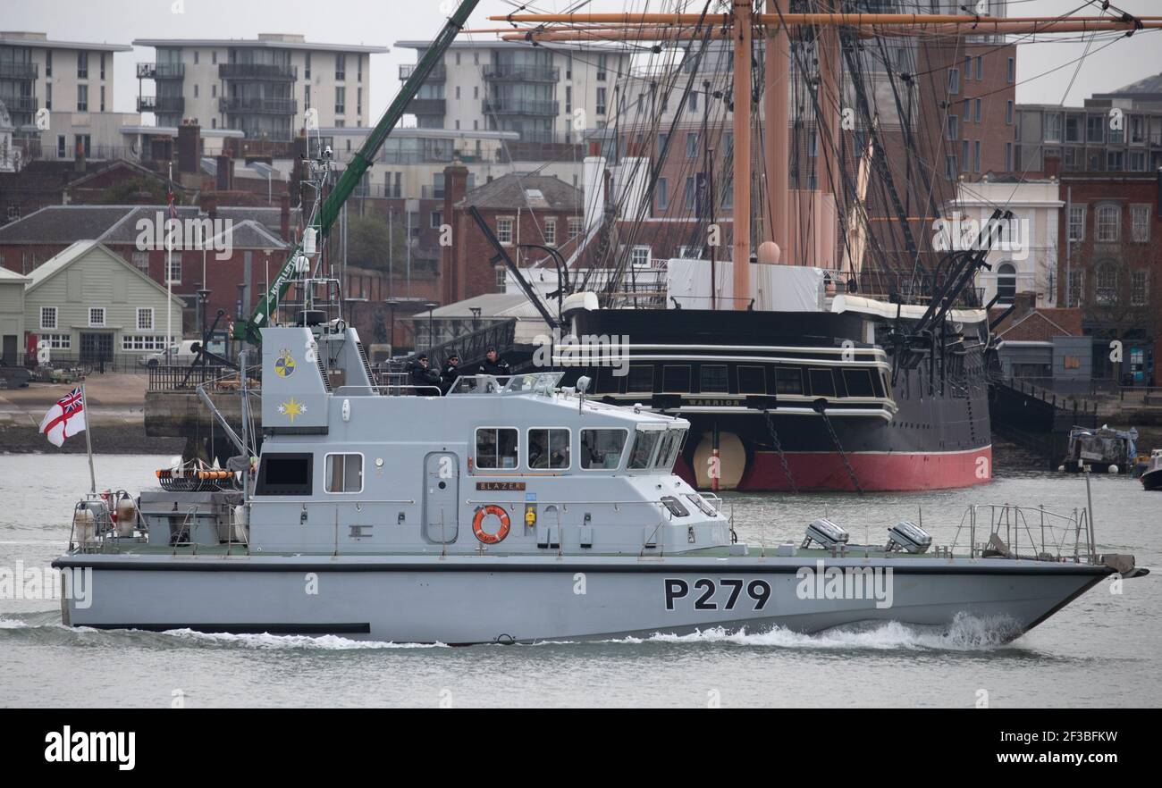 The Royal Navy archer class patrol vessel HMS Blazer passes HMS Warrior ...