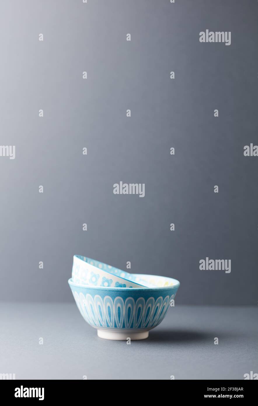 Traditional ceramic bowls on paper background. Copy space Stock Photo ...