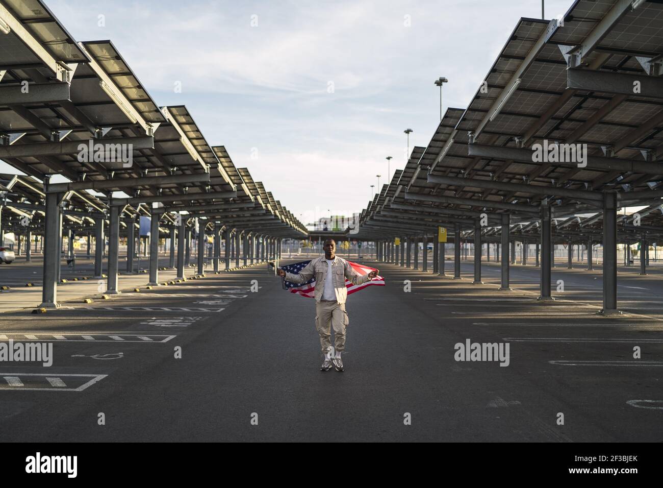 A closeup shot of a black male walki holding the flag of the USA Stock ...