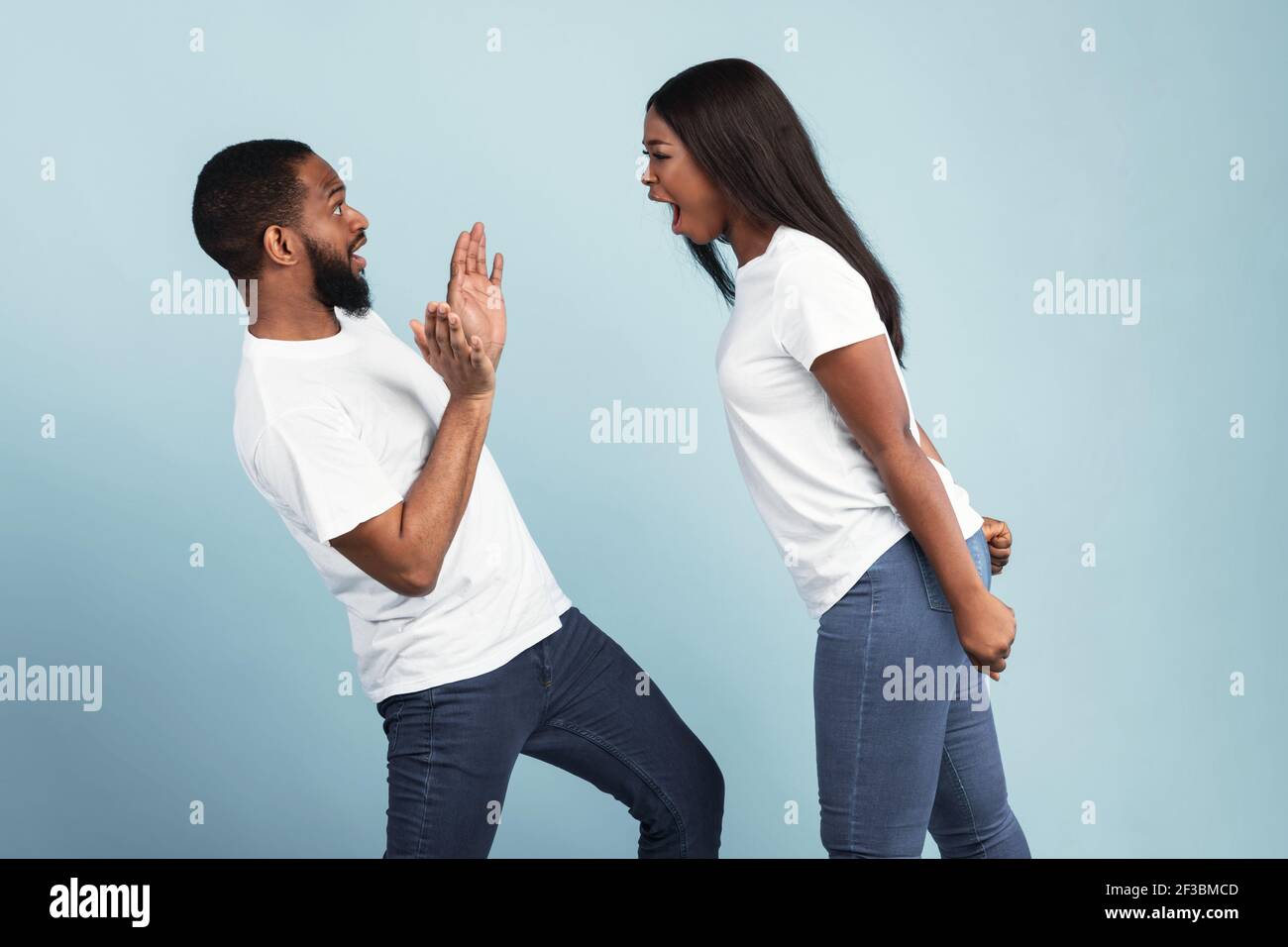 Afro couple arguing, woman yelling at scared man Stock Photo - Alamy