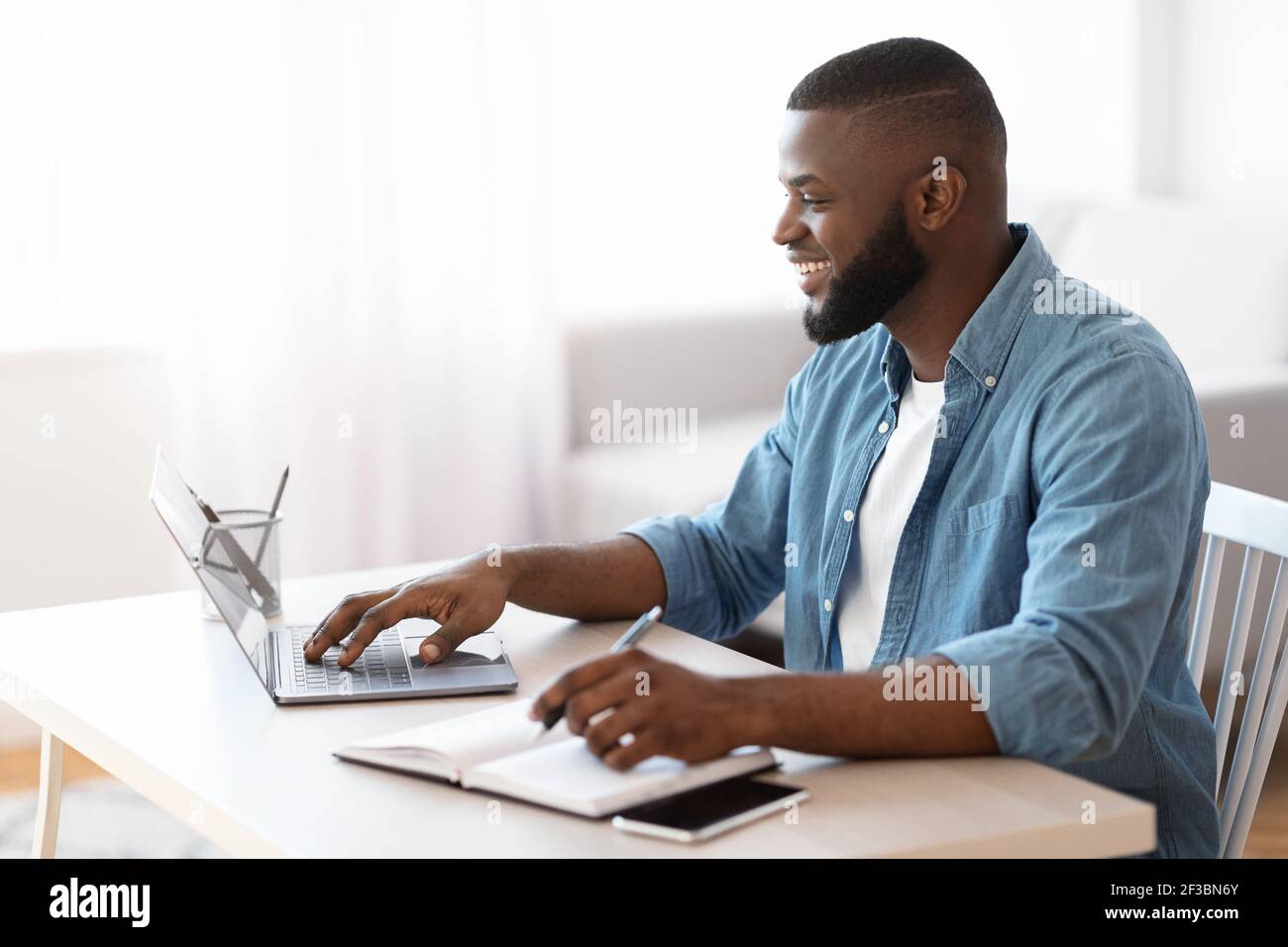 Online Education. Young Smiling Black Guy Study With Laptop At Home ...