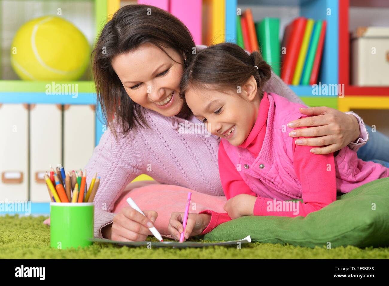 Portrait of little cute girl with mother drawing Stock Photo - Alamy