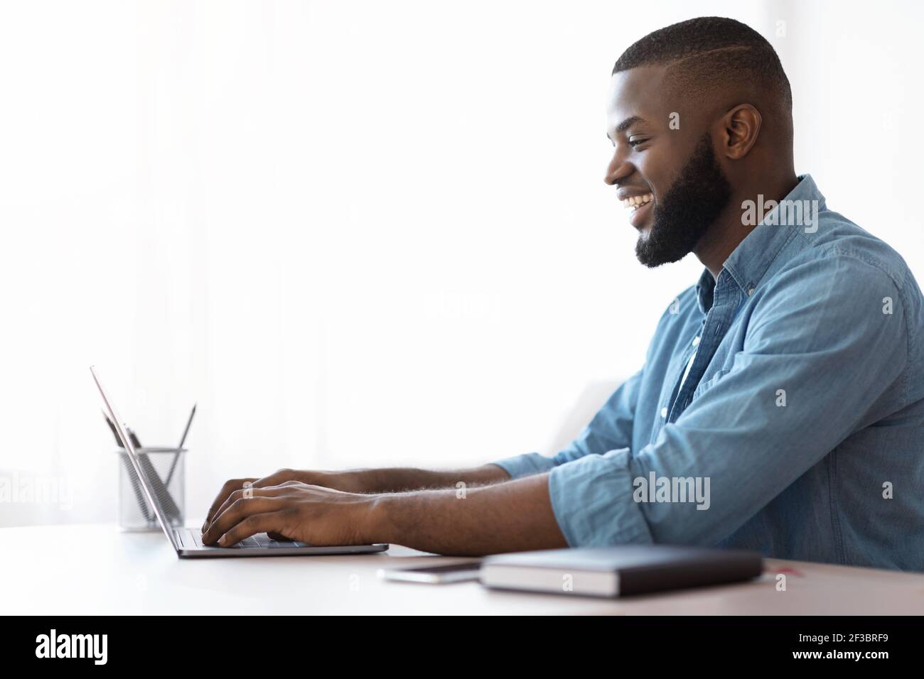 Side view young black businessman hi-res stock photography and images ...