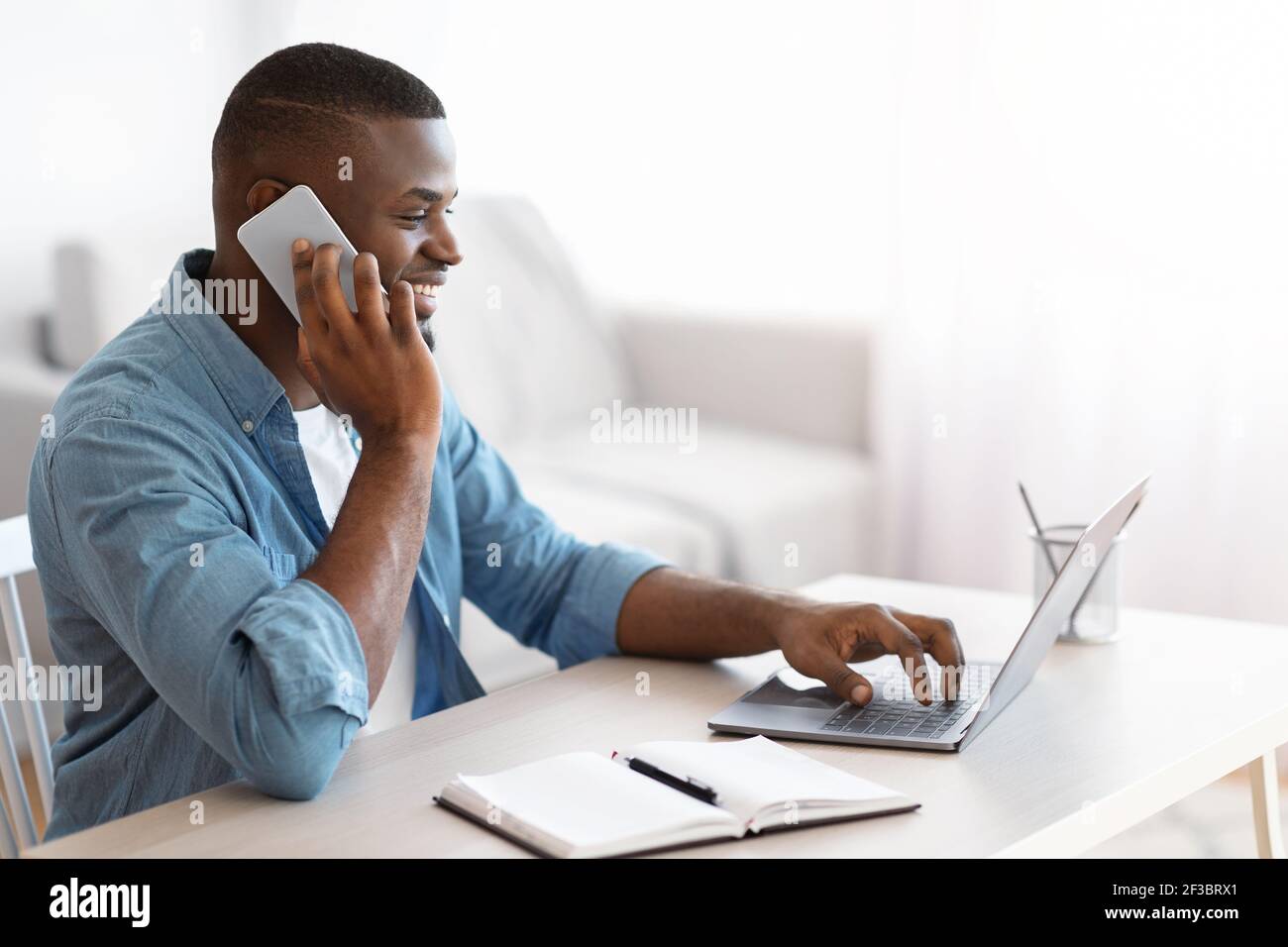 African work from home phone laptop hi-res stock photography and images ...