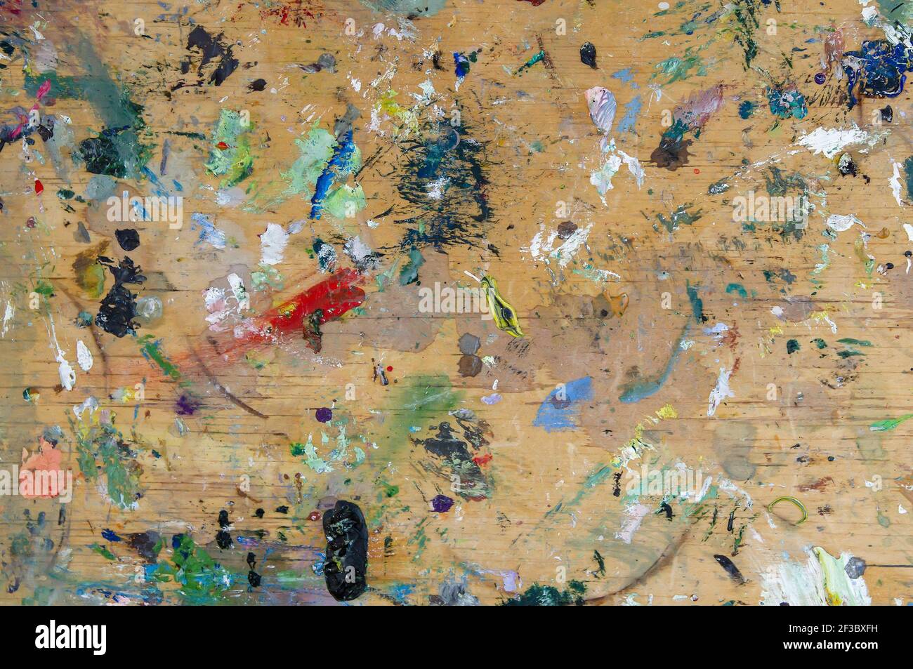 Paint splattered artist wooden desk, grunge background or texture Stock ...