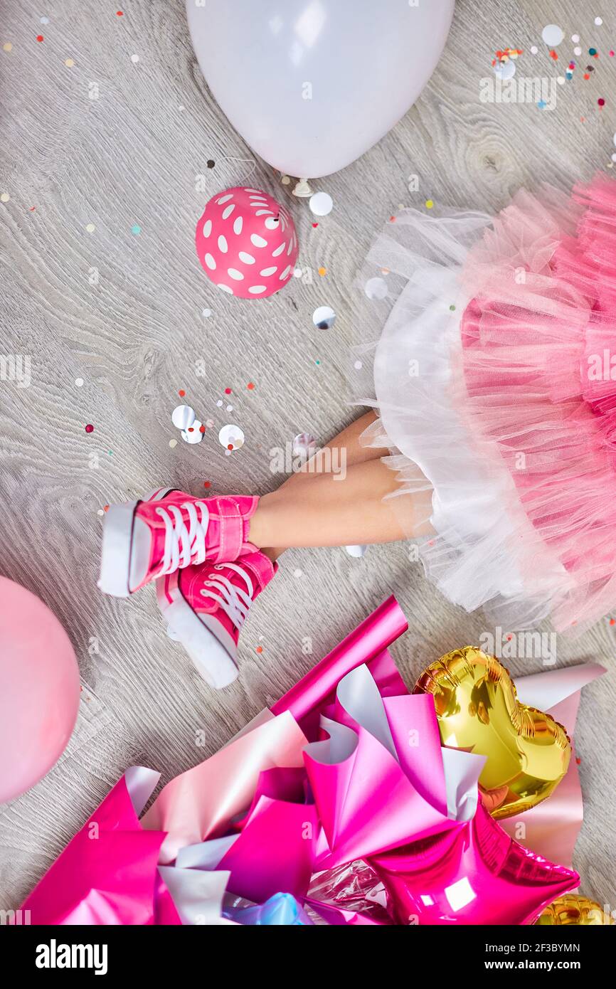 Creative lay out of funky leg of girl in pink sneakers and dress, flat ...