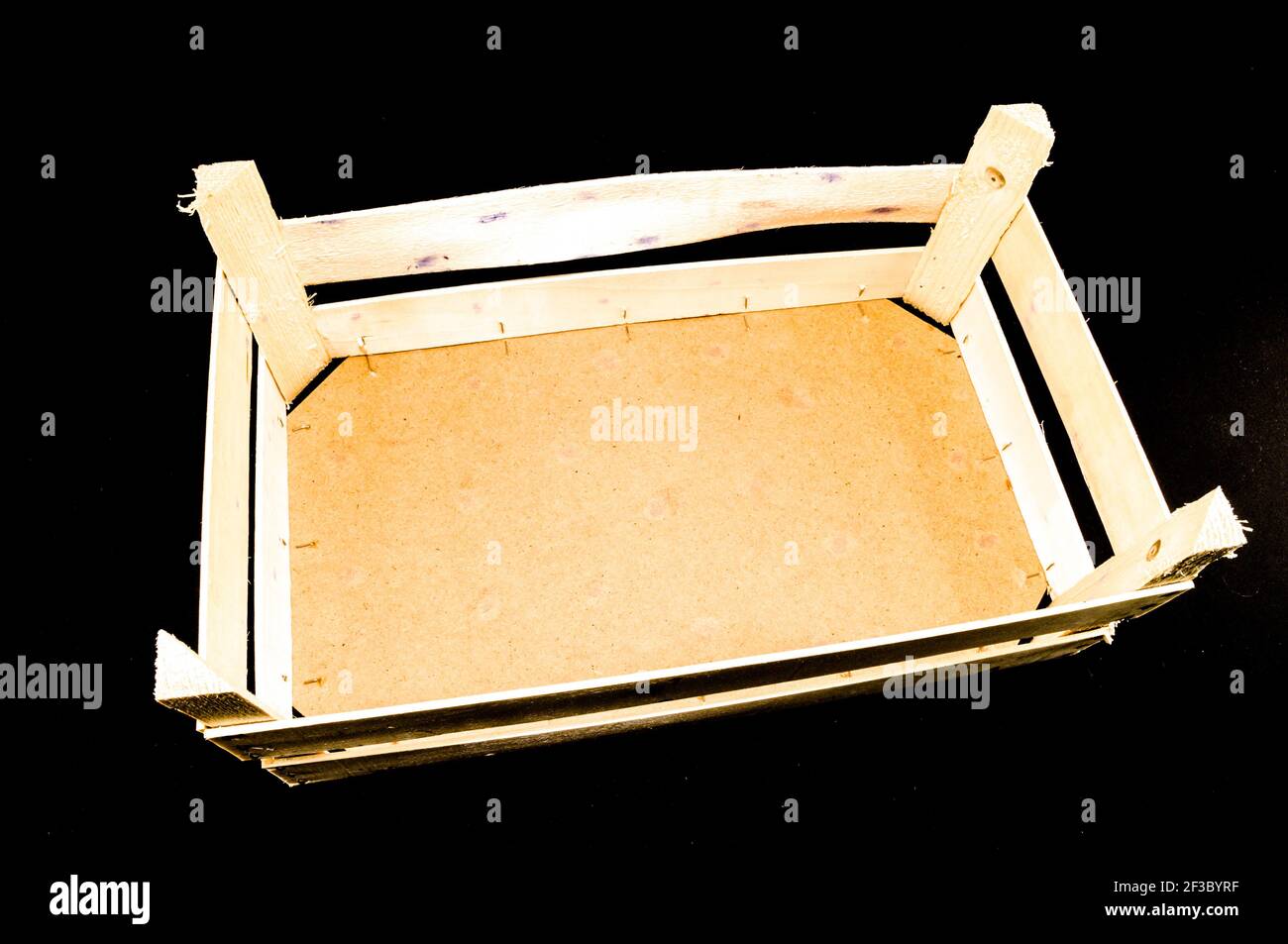 An empty fruit crate box on a black background Stock Photo - Alamy