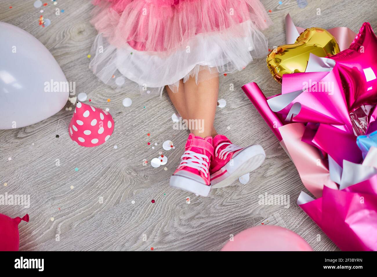 Creative lay out of funky leg of girl in pink sneakers and dress, flat ...