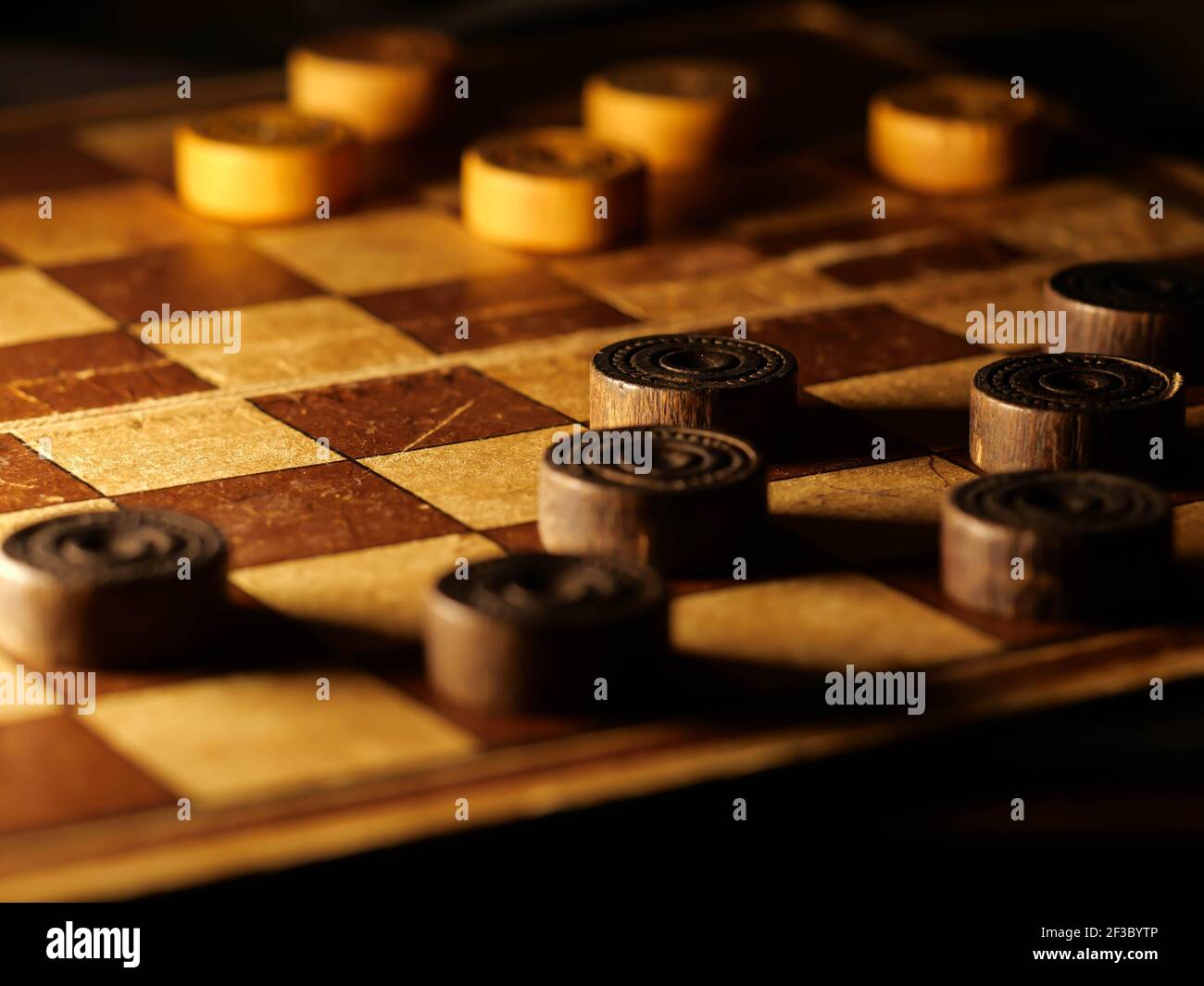 Vintage wooden checkerboard with brown and cream colored checkers Stock ...