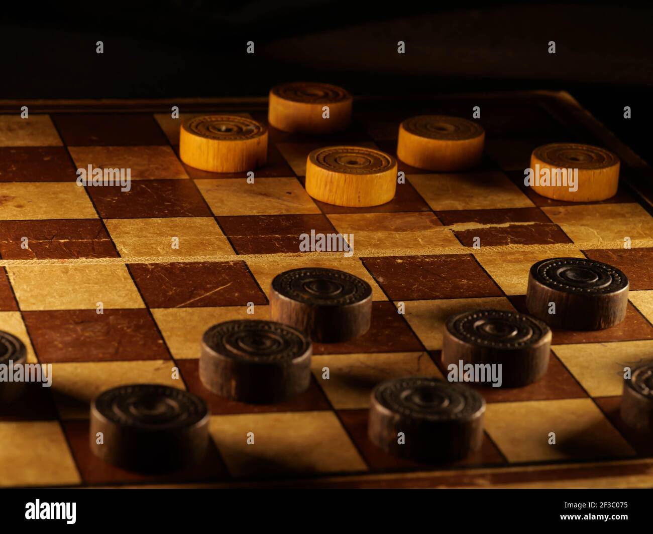 Vintage wooden checkerboard with brown and cream colored checkers Stock ...