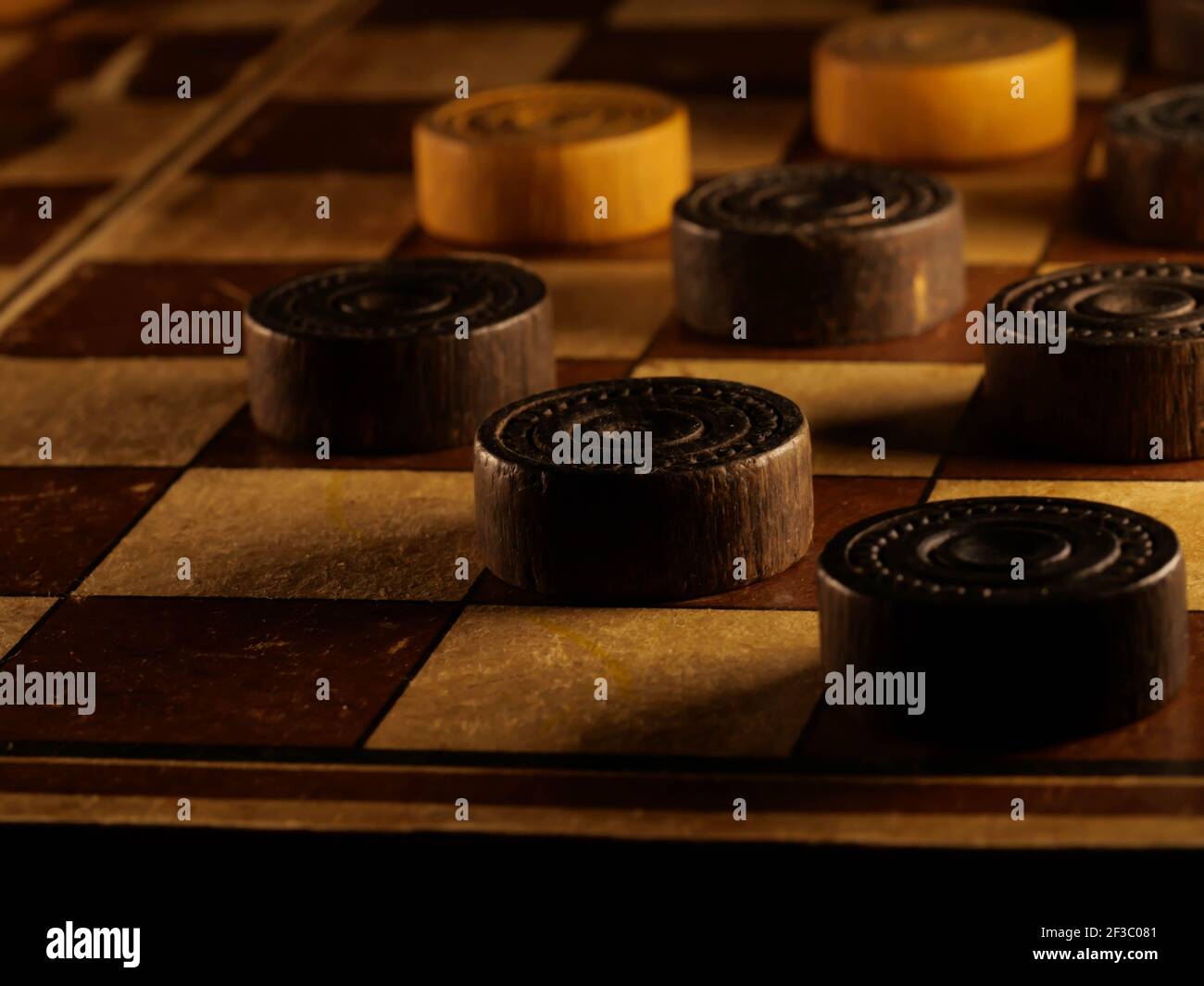 Vintage wooden checkerboard with brown and cream colored checkers Stock ...