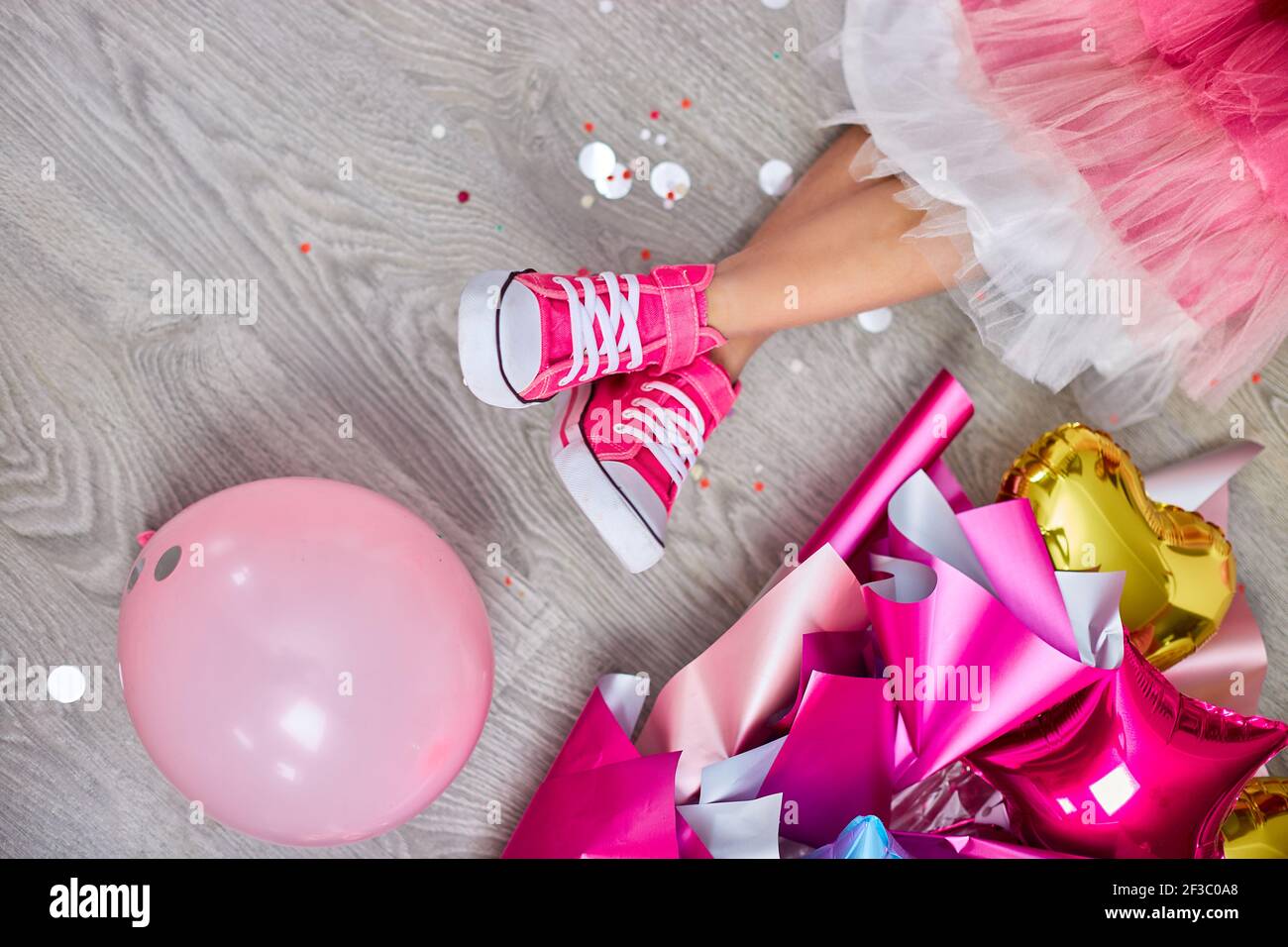 Creative lay out of funky leg of girl in pink sneakers and dress, flat ...