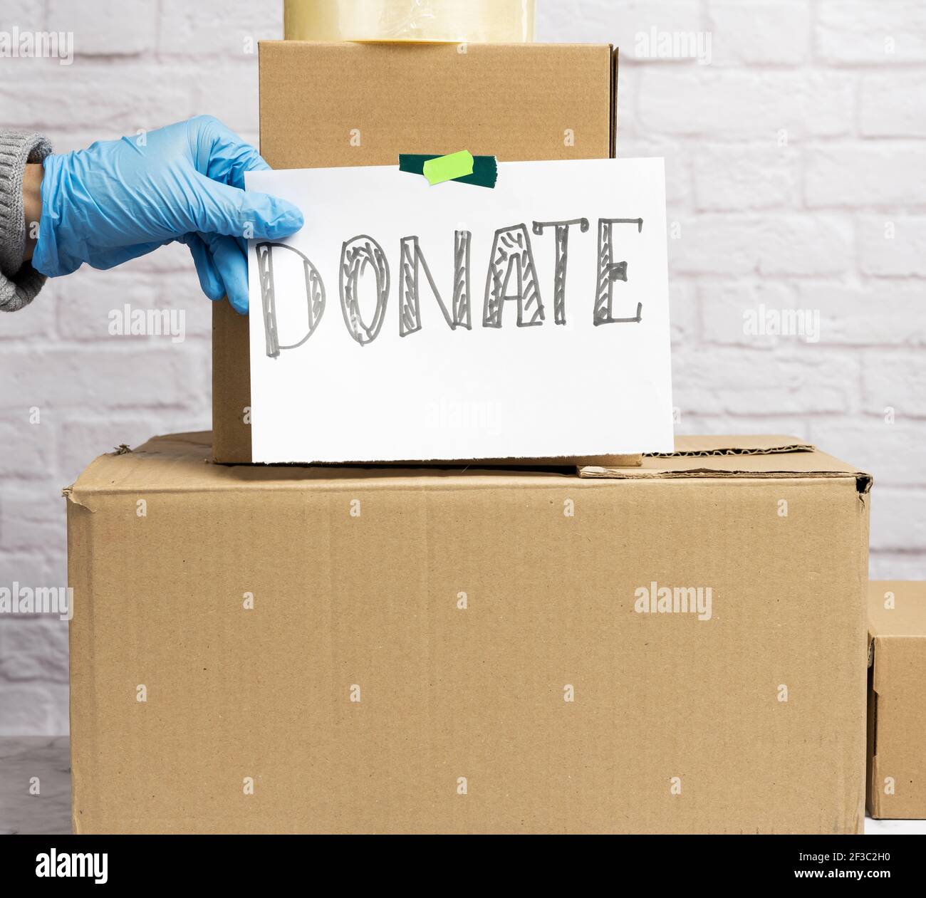 stack of cardboard boxes and white sheet of paper with inscription ...