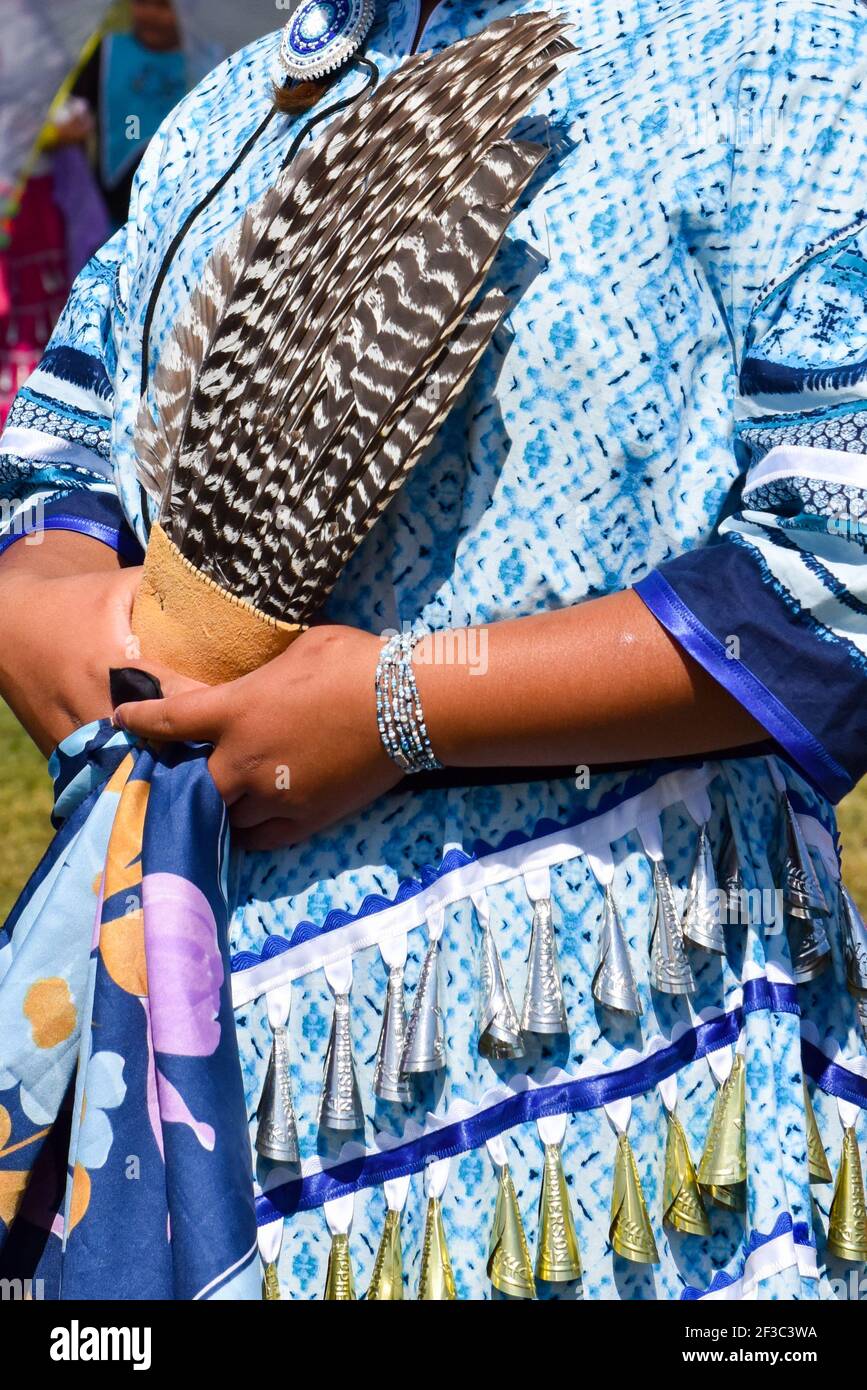 Native Girl holding ceremonial native feathers during a pow-wow ...