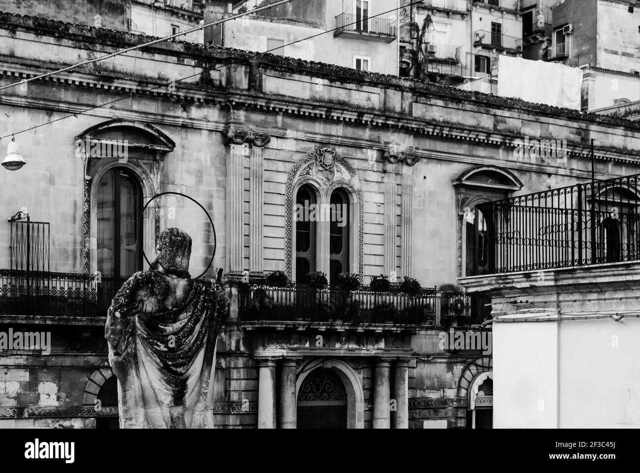 A monochrome view of a baroque statue in front of the St. Peters ...