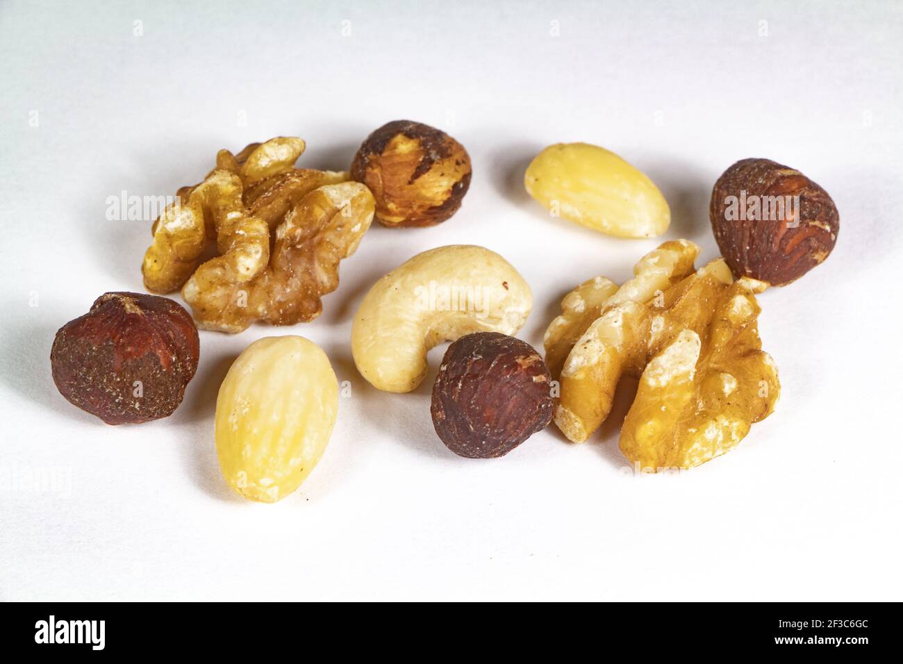 Walnut, hazelnut, almond and cashew on white background Stock Photo - Alamy