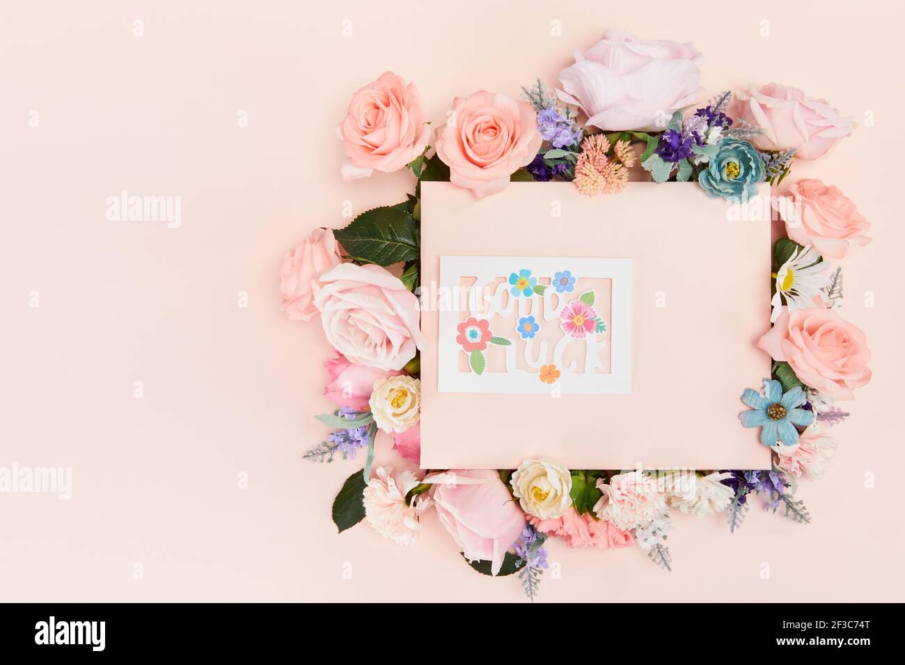 A "Good Luck" message on flowers against pink background Stock Photo ...