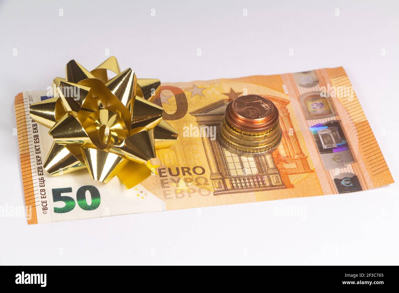 Euro banknotes, coins and bow as gift for Christmas or birthday Stock ...