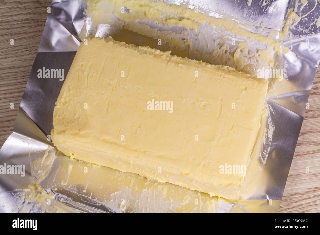 Open pack of salted butter on wooden background Stock Photo - Alamy