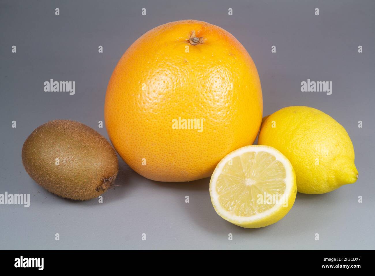 Winter fruits, grapefruit, kiwi and lemons on grey background Stock ...
