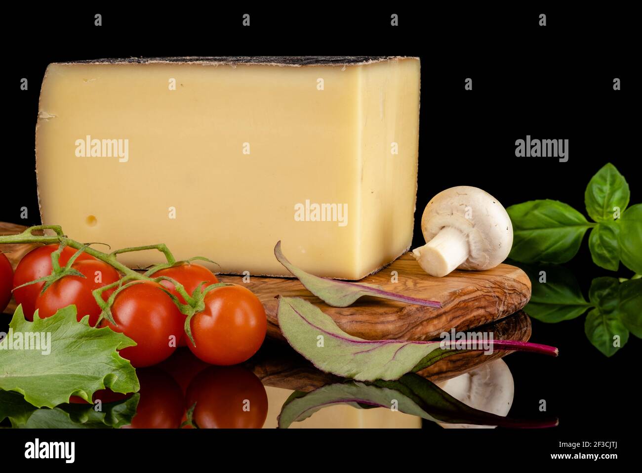 Delicious traditional Swiss melted raclette cheese with vegetables ...