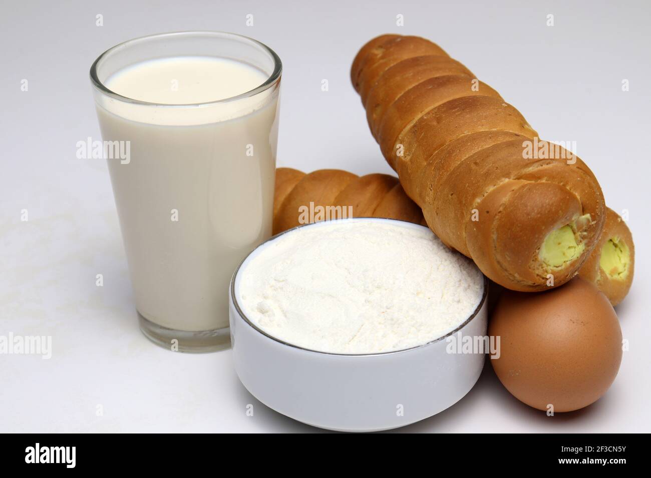 cream roll and milk with atta and egg on white background Stock Photo ...