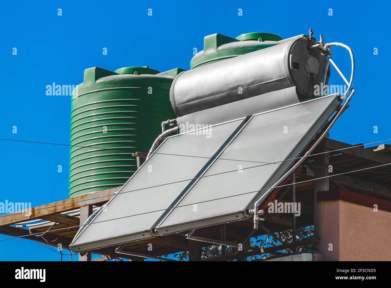 Solar water heater on the roof against the background of the sky. Using ...