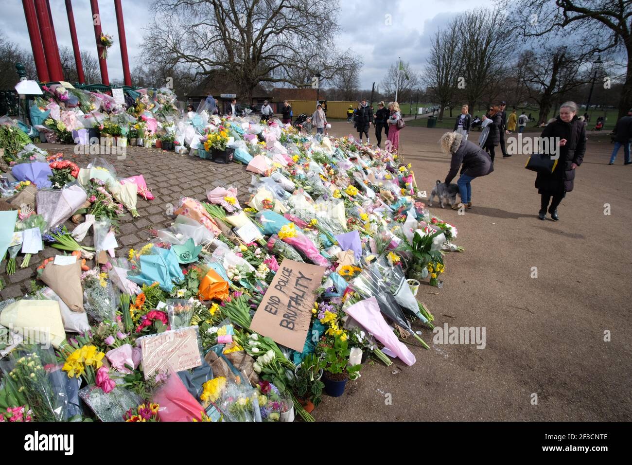 London, UK. 16th March, 2021. Mourners place flowers on the bandstand ...