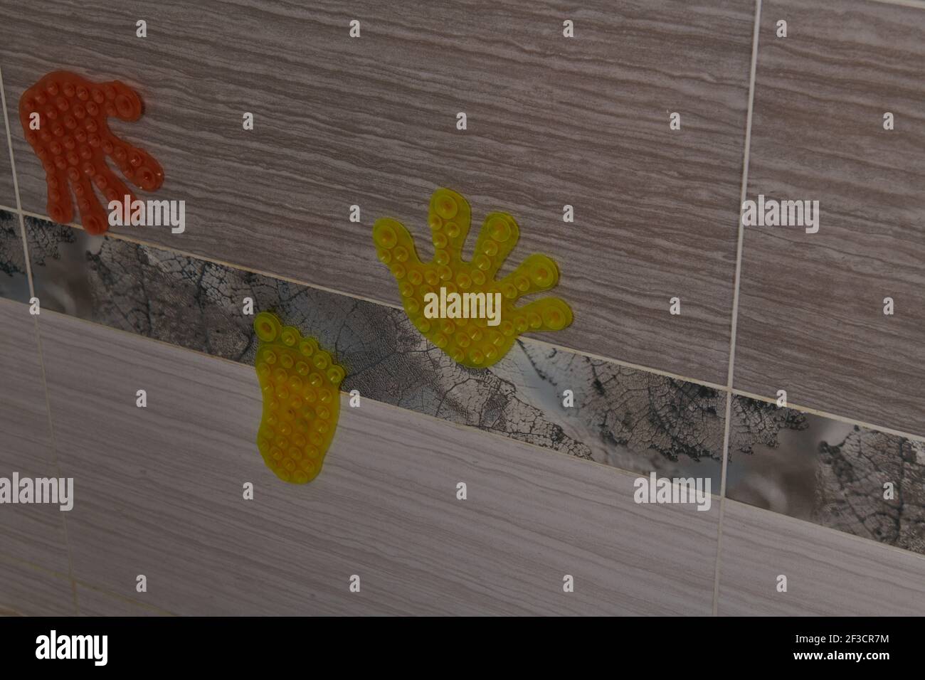 colored rubber hands on a tiled wall Stock Photo - Alamy