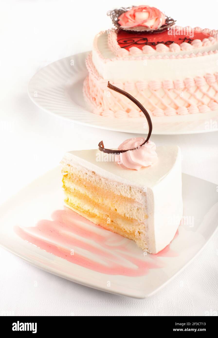 A styled cake and a piece of that cake in front of it Stock Photo - Alamy