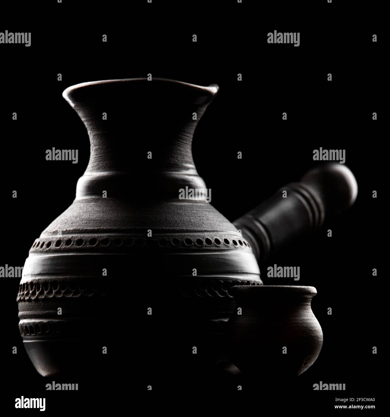 Traditional black clay cezve for brewing coffee Stock Photo - Alamy