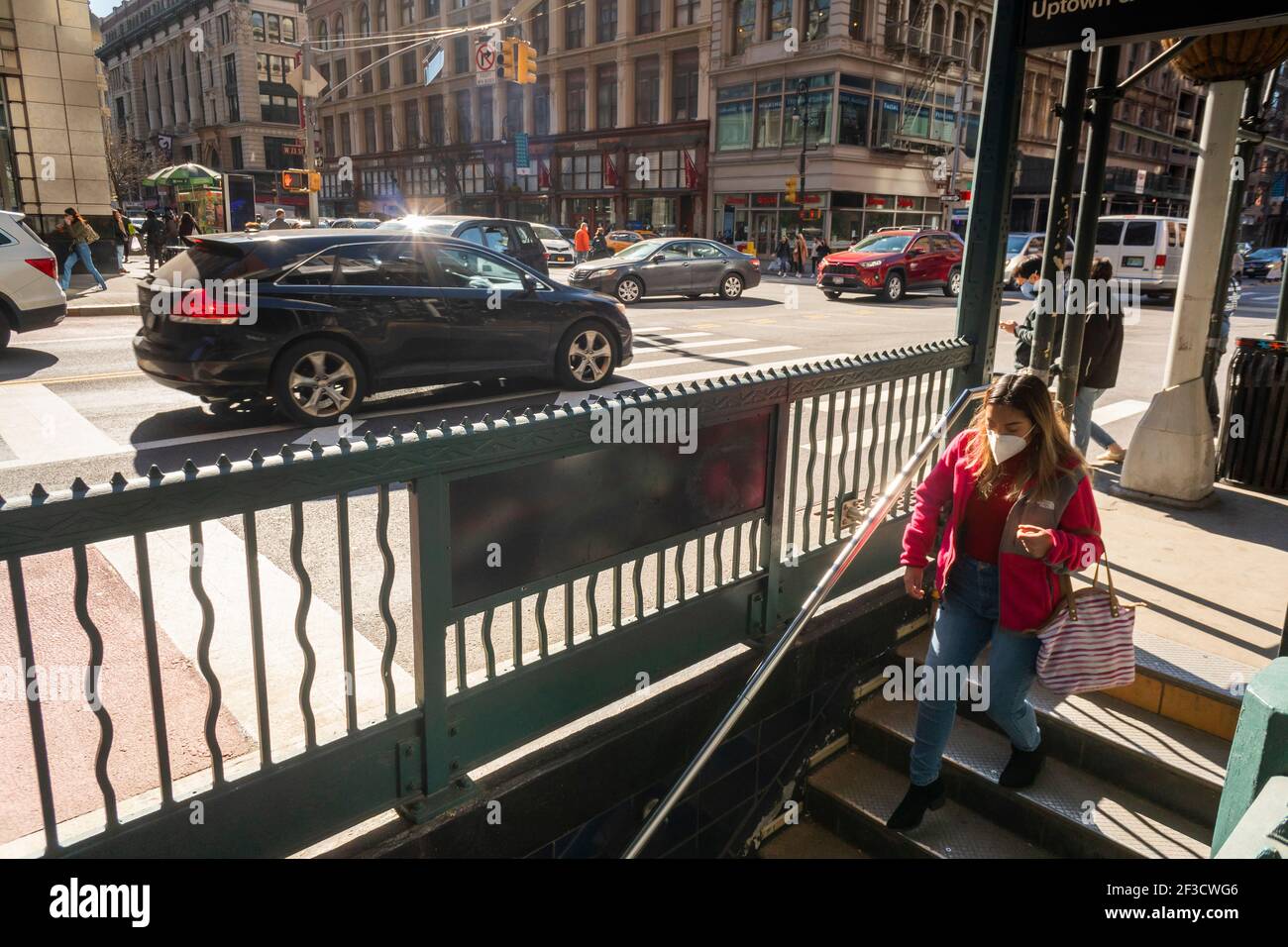 Masked traveler enters the subway in the Chelsea neighborhood of New ...