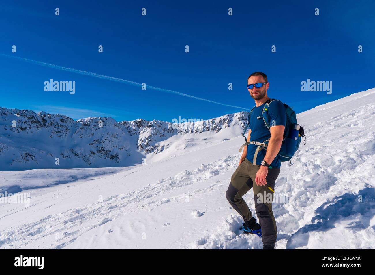 Panoramic banner of man trekking in snow covered mountain. Sport ...