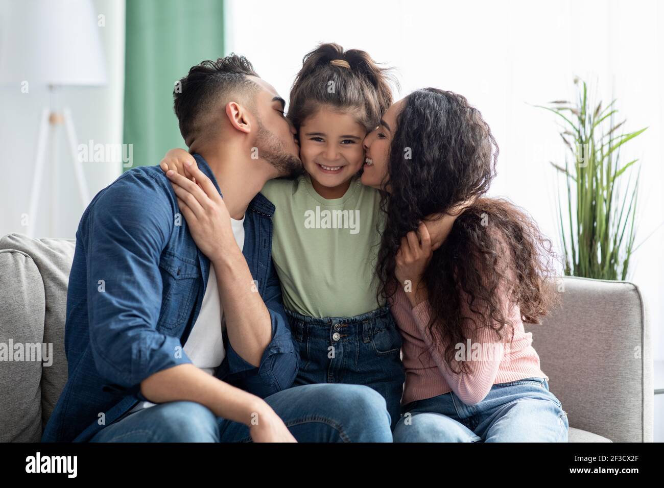 Family Love. Caring Parents Kissing Their Little Daughter, Bonding ...