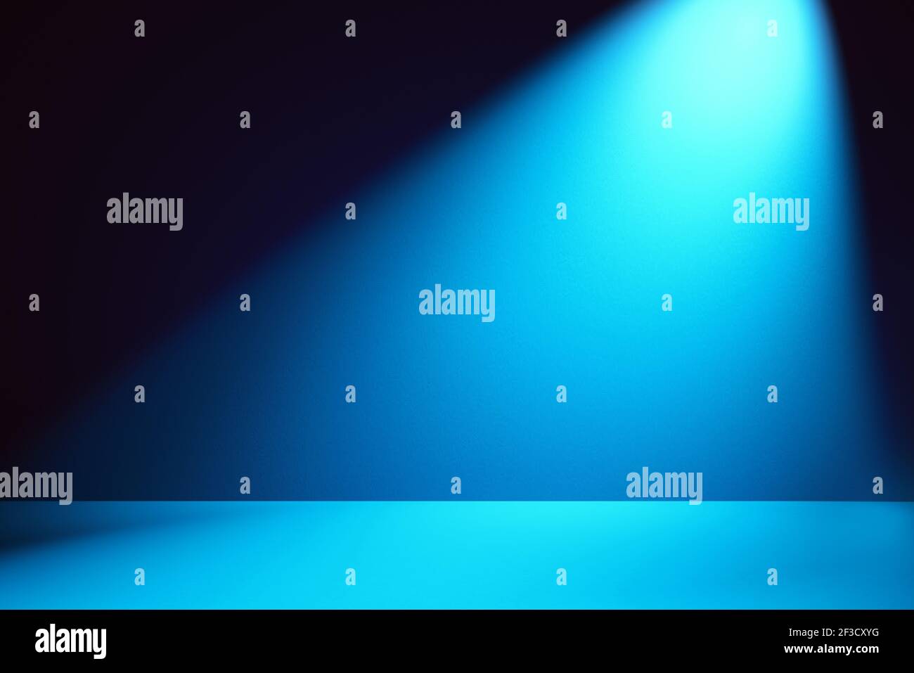 Empty light blue studio background illuminated by spotlight. Place for ...