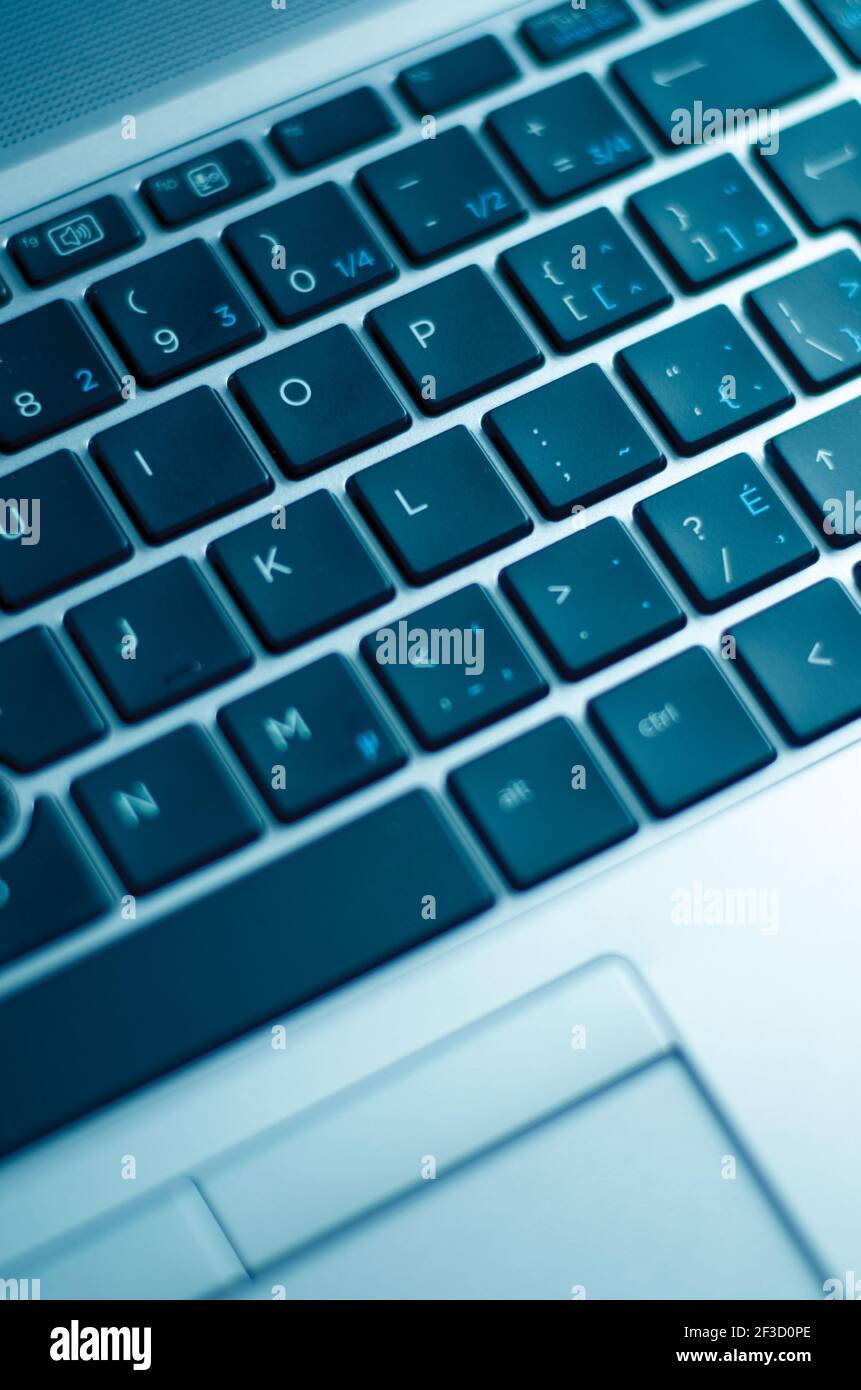 Diagonal View of Blue Toned Laptop Keyboard Vertical Stock Photo - Alamy