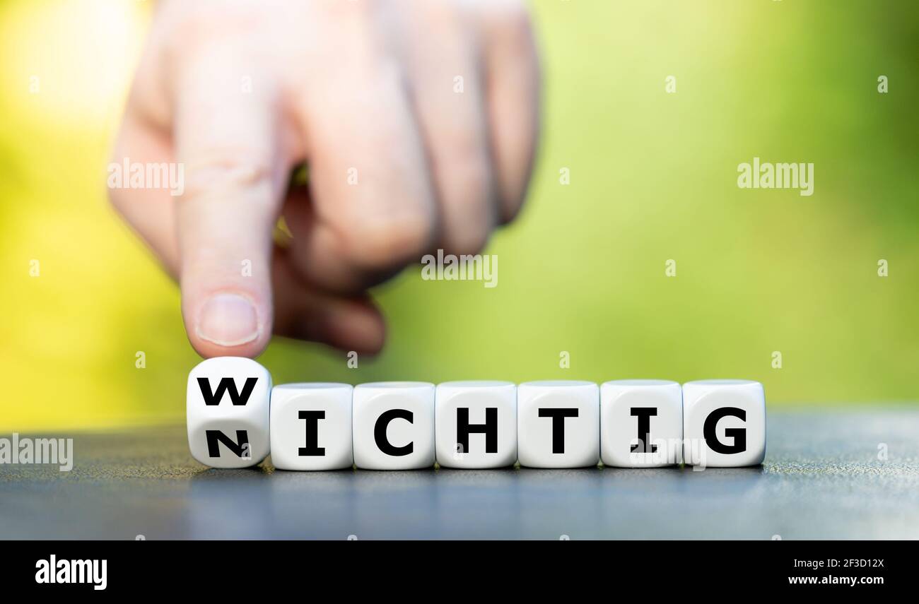 Hand turns dice and changes the German word "nichtig" (unimportant) to ...