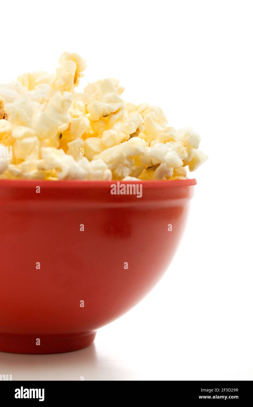 Close Side View of Buttered Popcorn in a Red Bowl Isolated on White ...