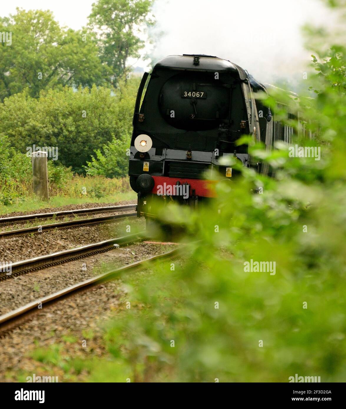 Battle of Britain class pacific No 34067 Tangmere passing through rural ...