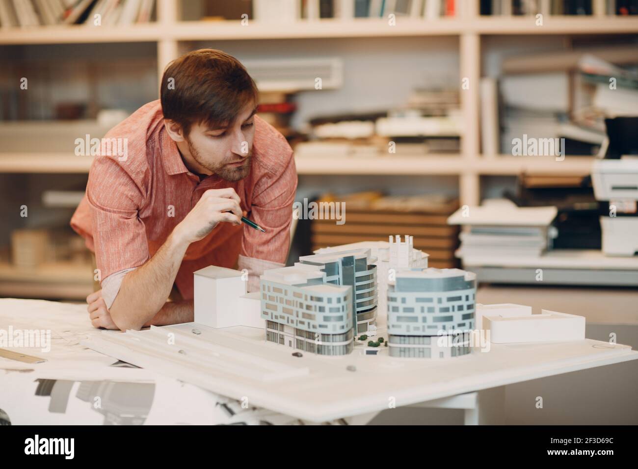 Architect with blueprints and layout design project at office bureau ...