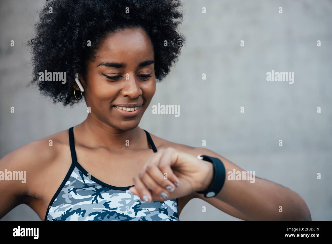 Fitness woman checking time on smart watch Stock Photo - Alamy